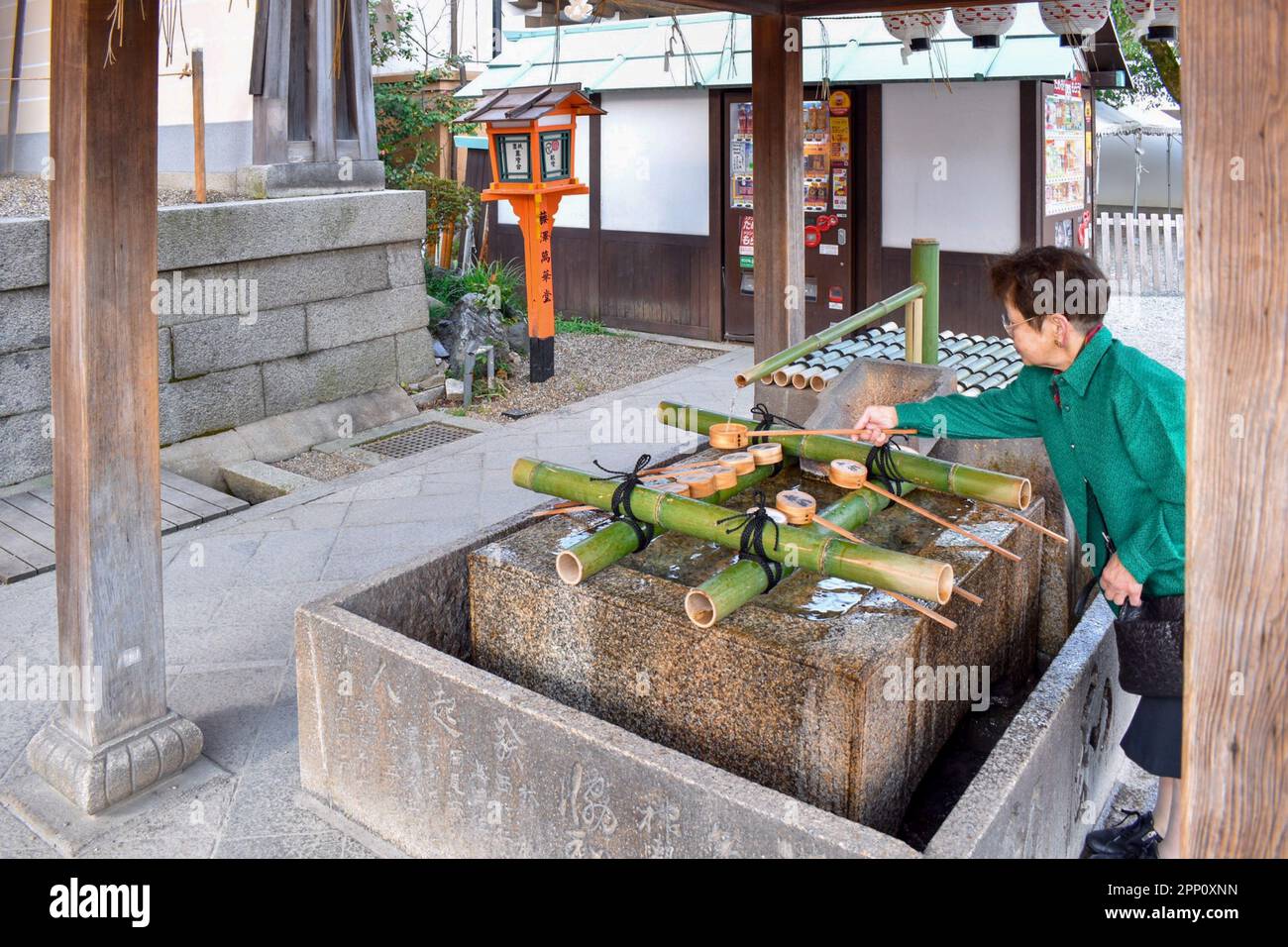 Kyoto, Japan - April 1st 2019; Old woman is washing her hands in ...
