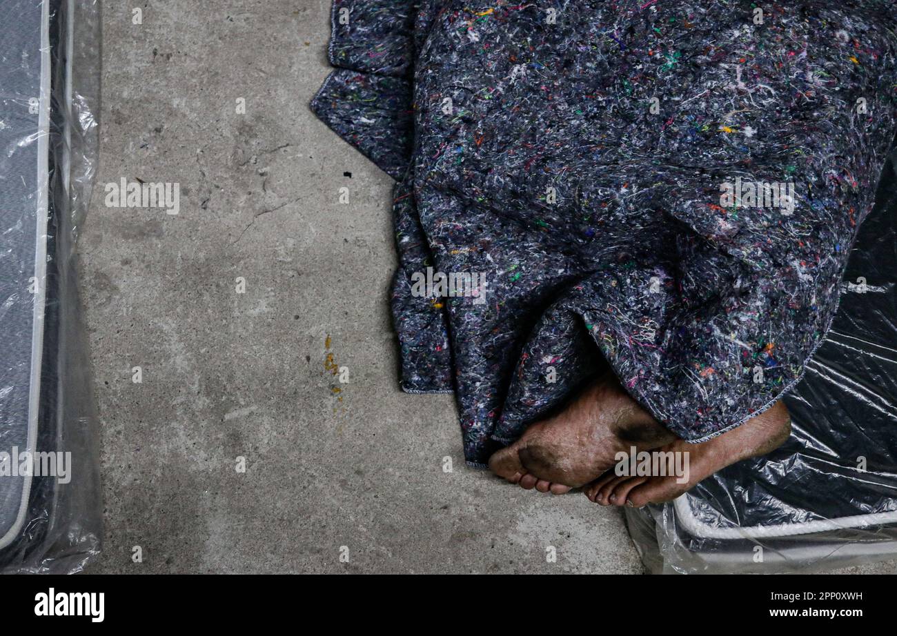 20 April 2023, Brazil, São Paulo: A homeless man sleeps in an emergency ...