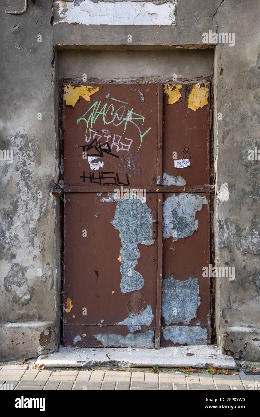 Old metal doors at the damaged entrance Stock Photo - Alamy