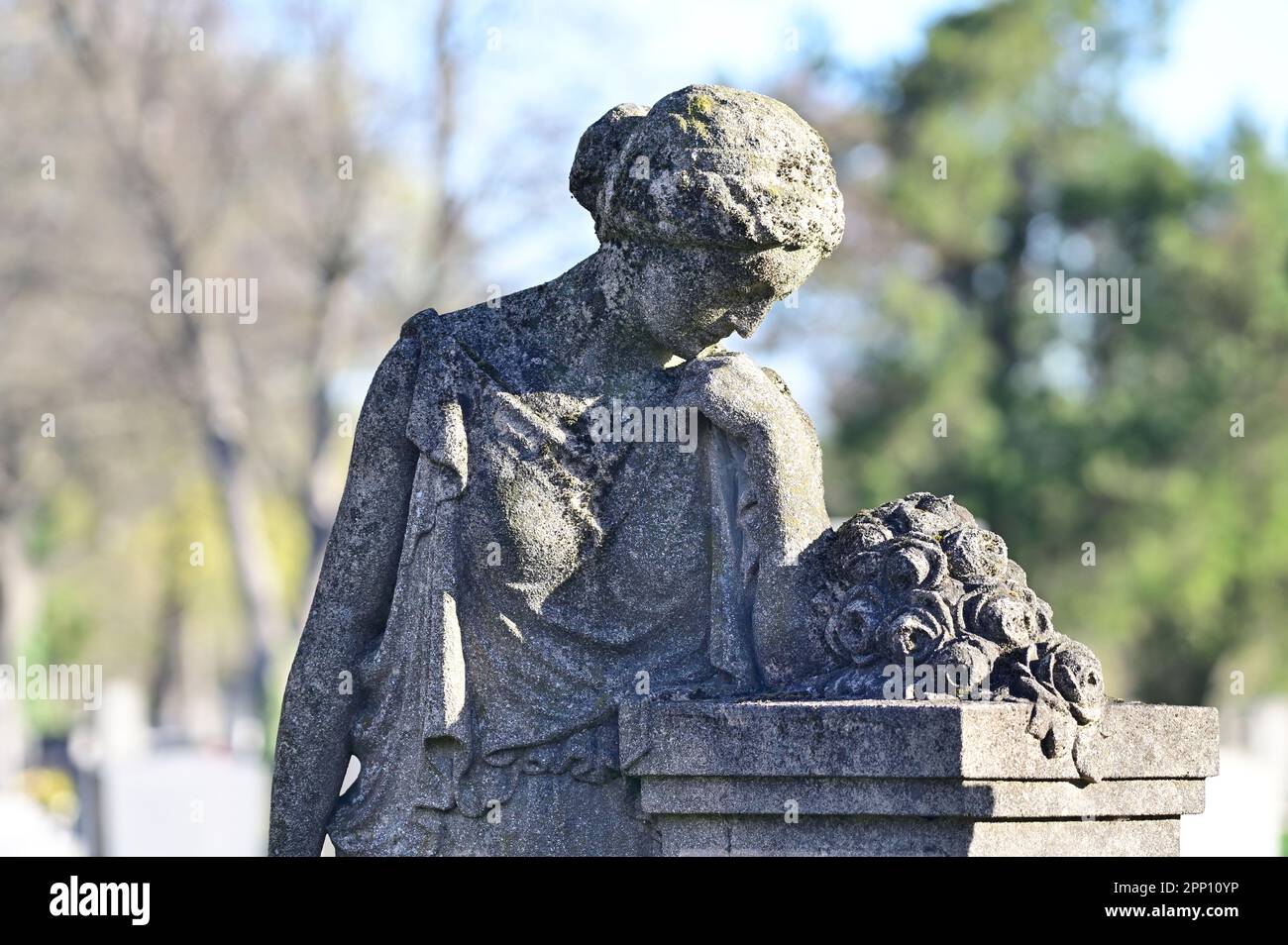 Vienna, Austria. Vienna Central Cemetery. Old weathered stone statue at ...