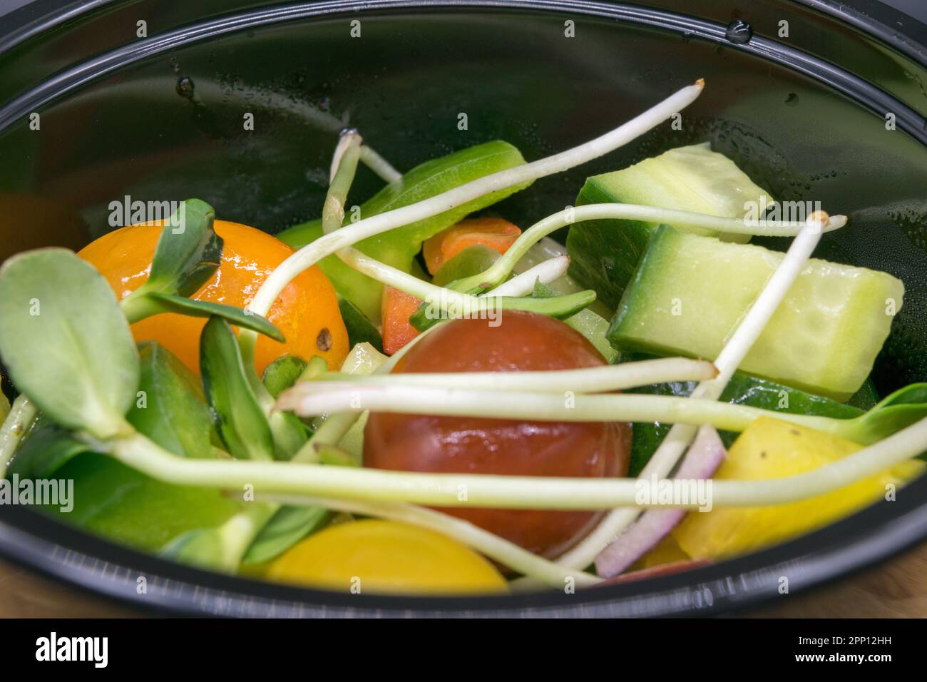 Healthy diet. A close-up view of a fresh salad with tomatoes, peppers ...