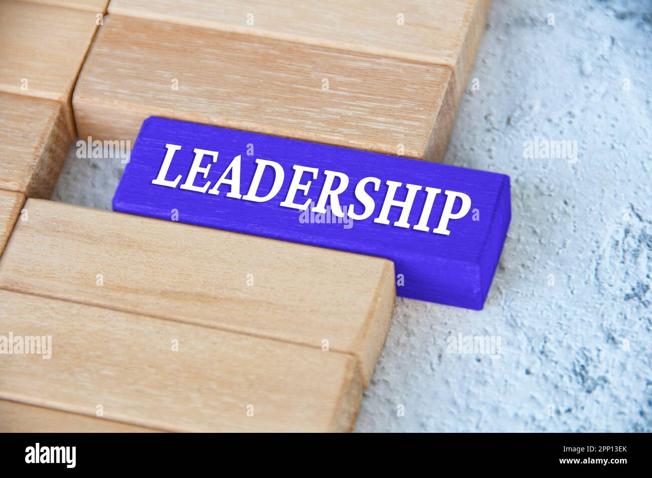 Leadership text on blue wooden block separated from the rest of the ...