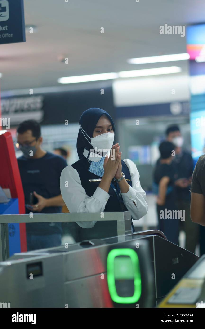 Friendly female officer greeting the passengers at the entry gate at ...