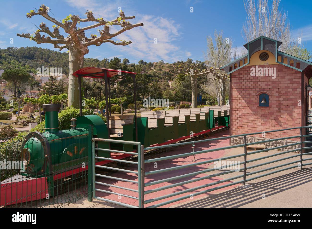 Miniature Journey: A Small Passenger Train and Station Amidst Greenery ...