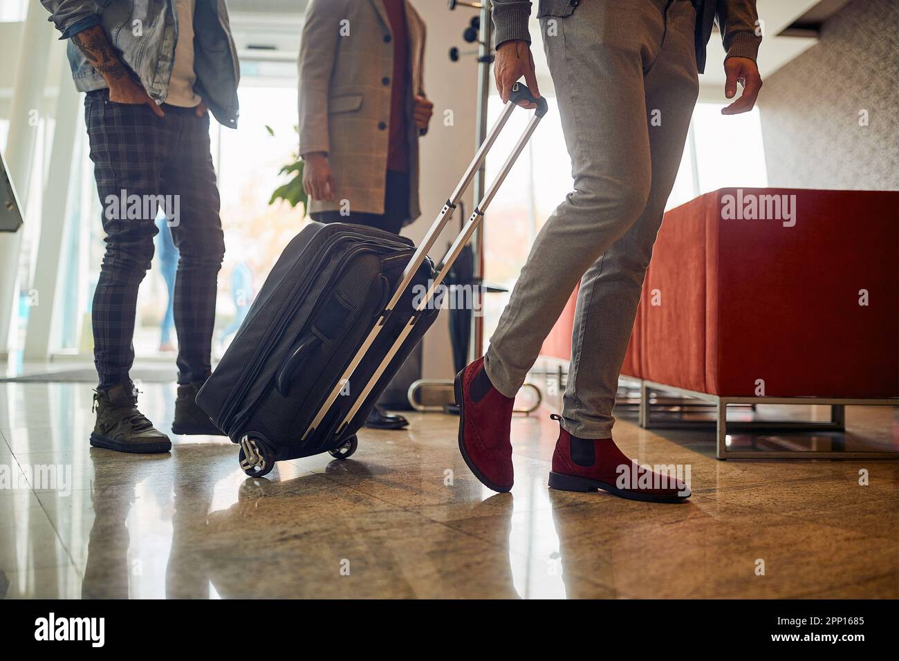 Group of work colleagues arriving to a hotel on a business trip Stock ...