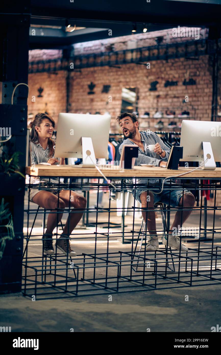 Beautiful young man and woman working together on pc, teamwork. Man ...