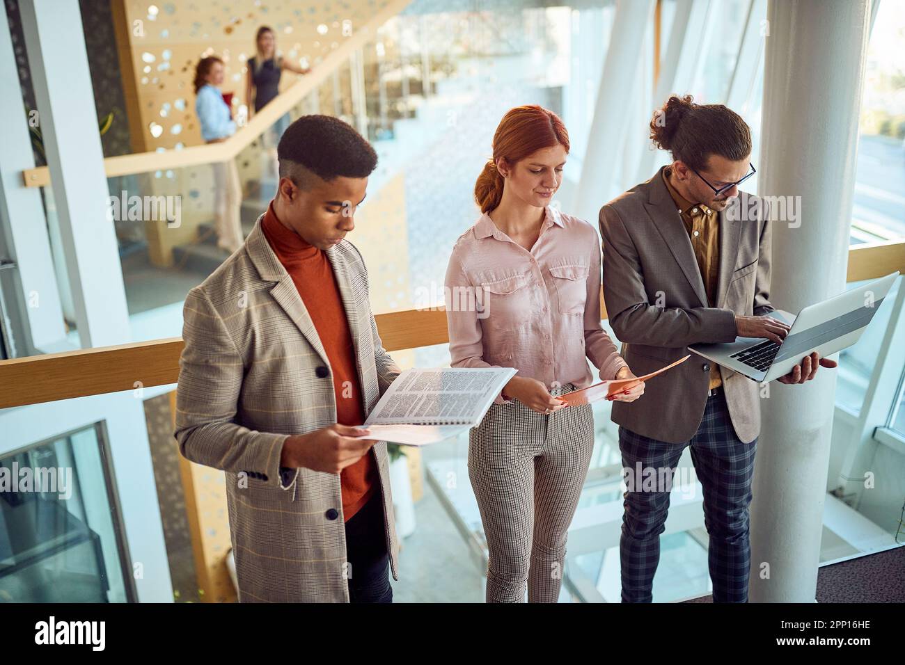 Young business people are standing in a pleasant atmosphere in the ...