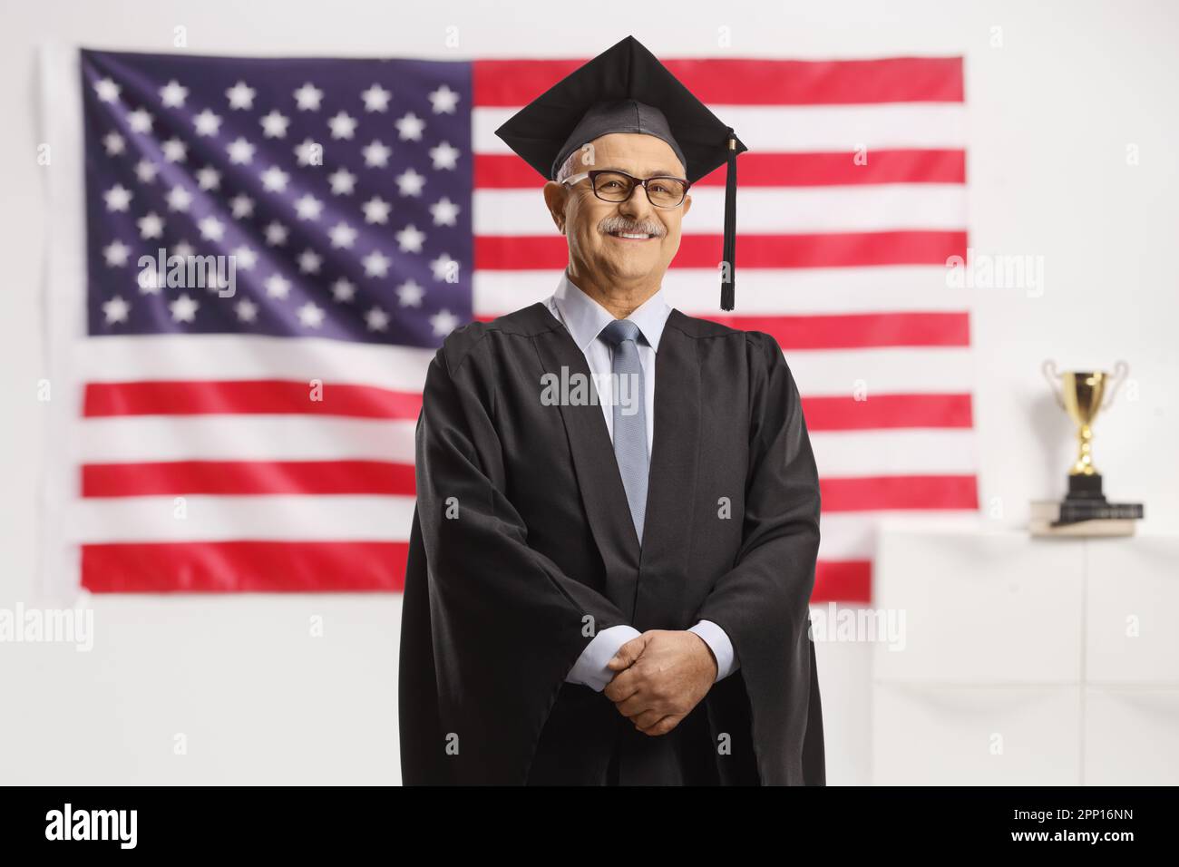 University dean standing in front of a USA flag Stock Photo - Alamy