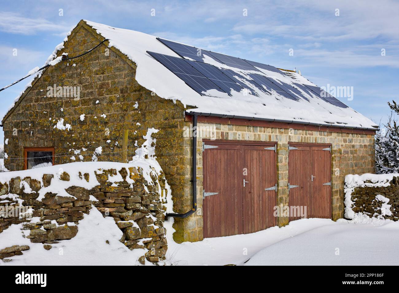 Snow partly covers solar panels on a double garage the morning after ...