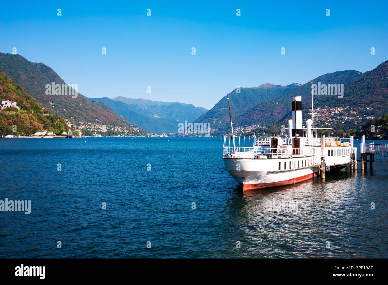 Beautiful landscape of lake Como with a white boat Stock Photo - Alamy