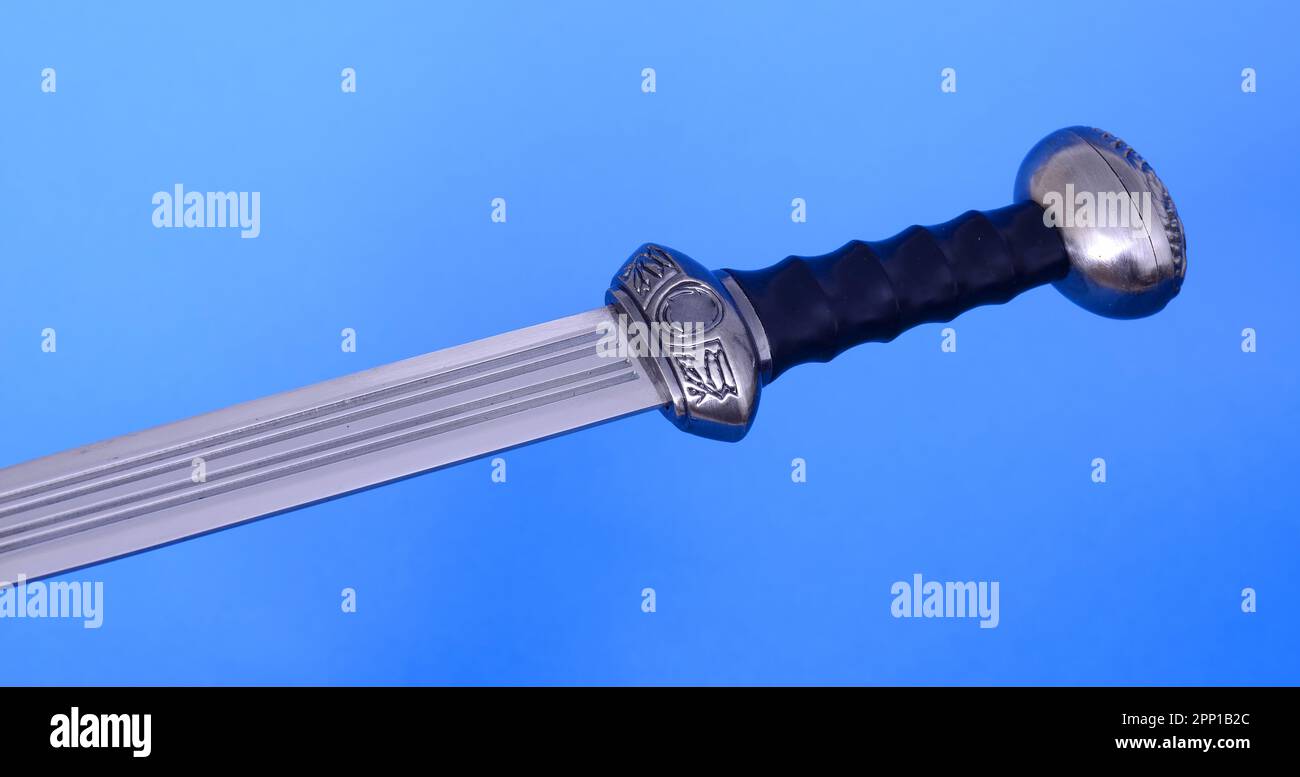 Gladius blade, guard, and hilt isolated over blue Stock Photo - Alamy