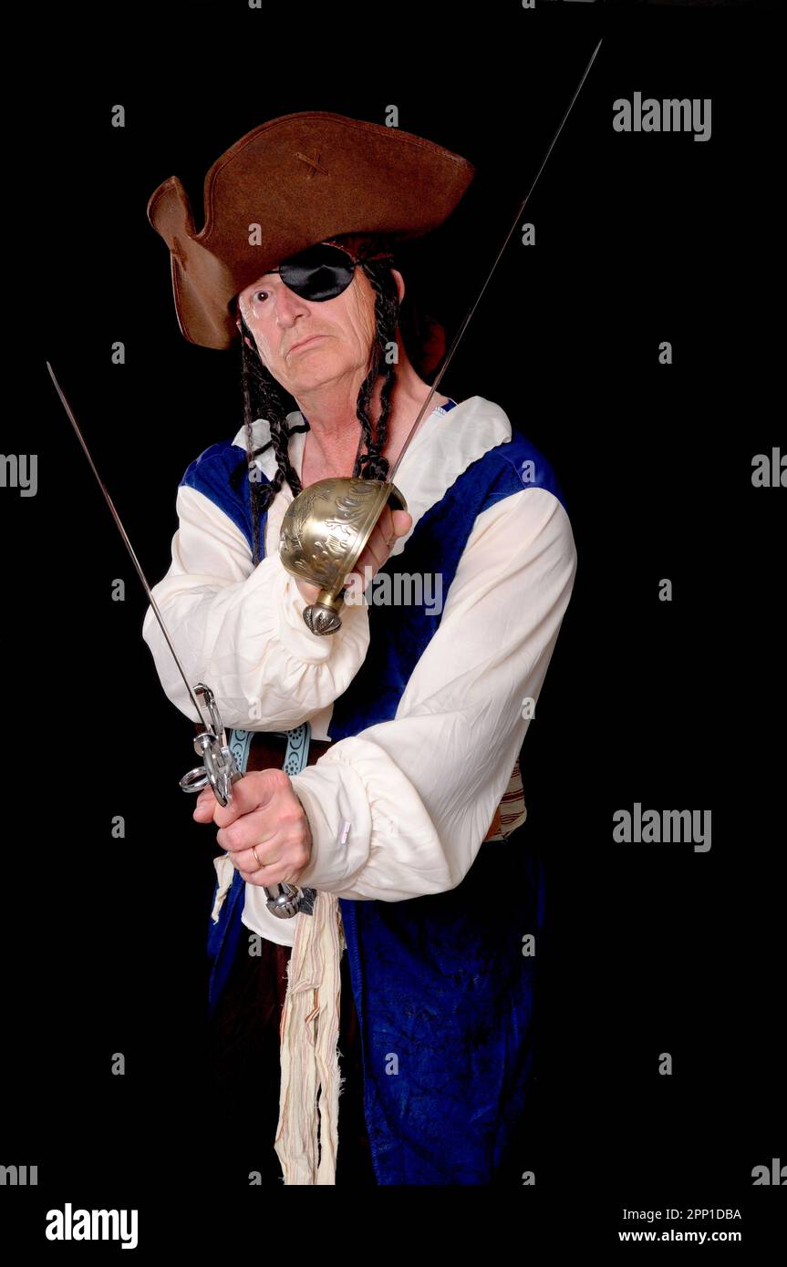 Pirate isolated on black with a cutlass Stock Photo - Alamy