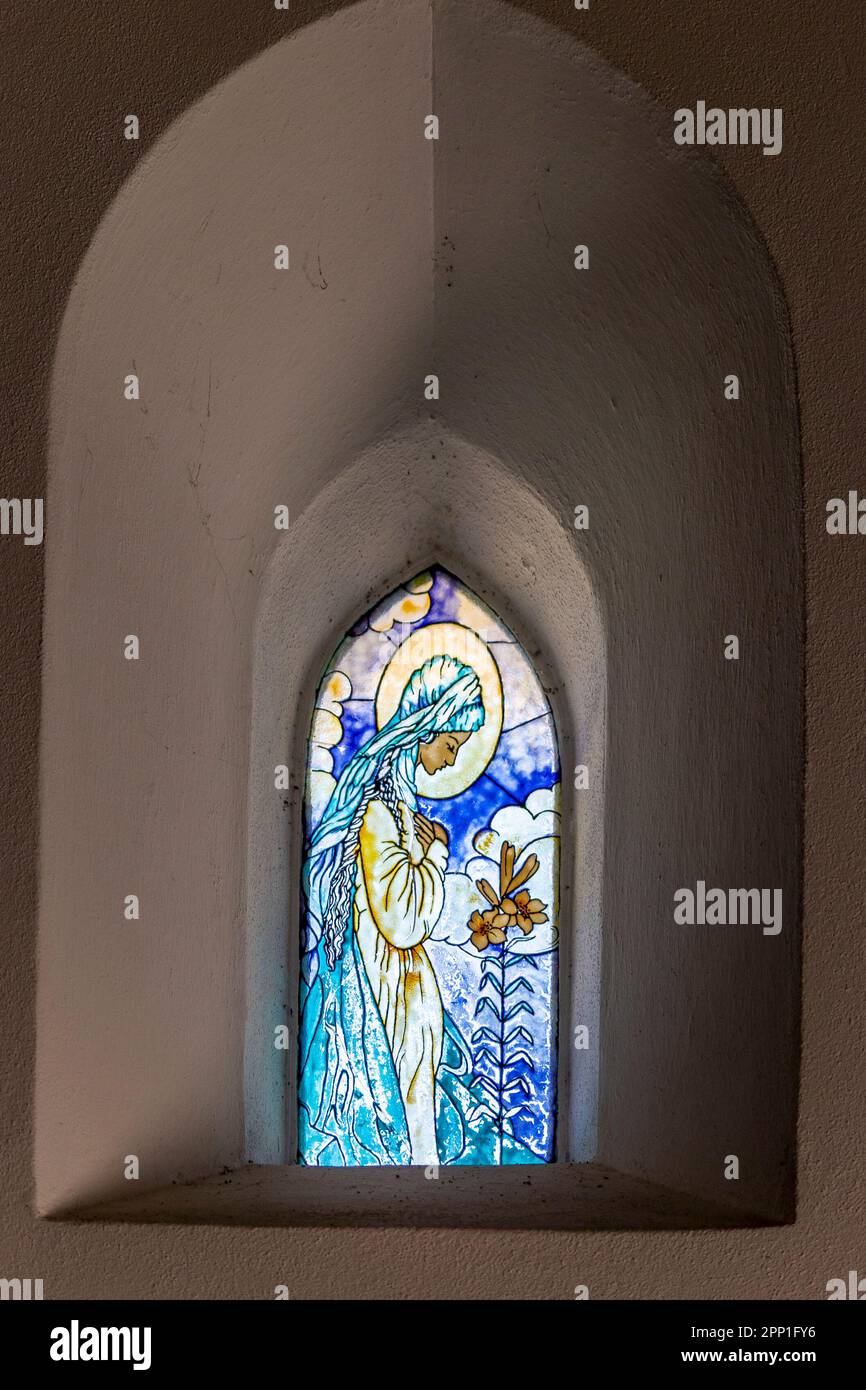 Stained glass window with religious depictions inside a Christian ...