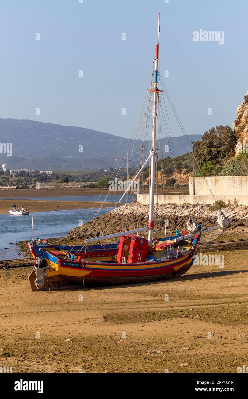 Beautiful Portuguese traditional fishing boat painted yellow, blue and ...