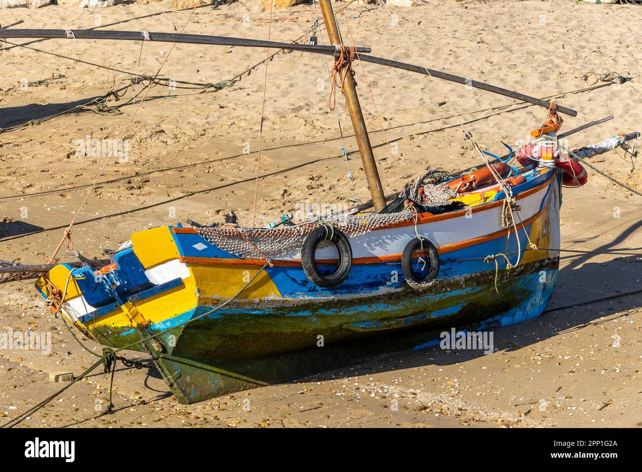 Beautiful Portuguese traditional fishing boat painted yellow, blue and ...