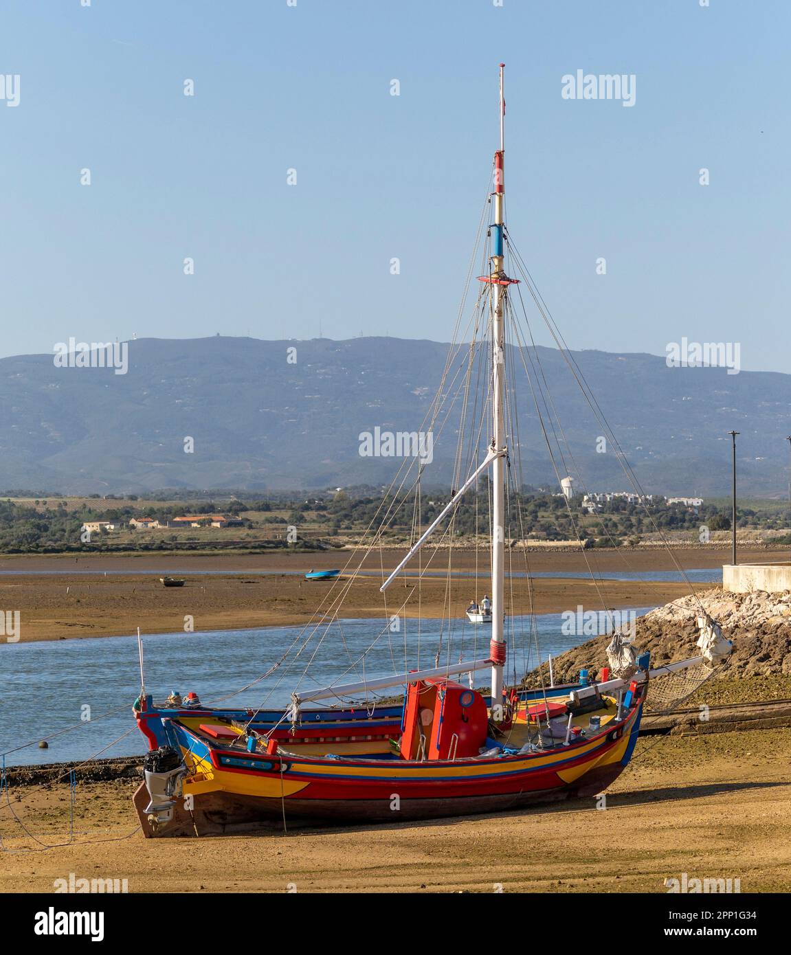 Beautiful Portuguese traditional fishing boat painted yellow, blue and ...