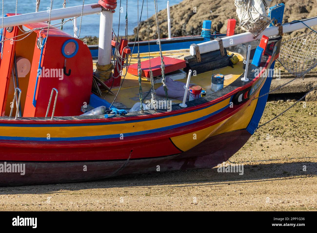 Beautiful Portuguese traditional fishing boat painted yellow, blue and ...