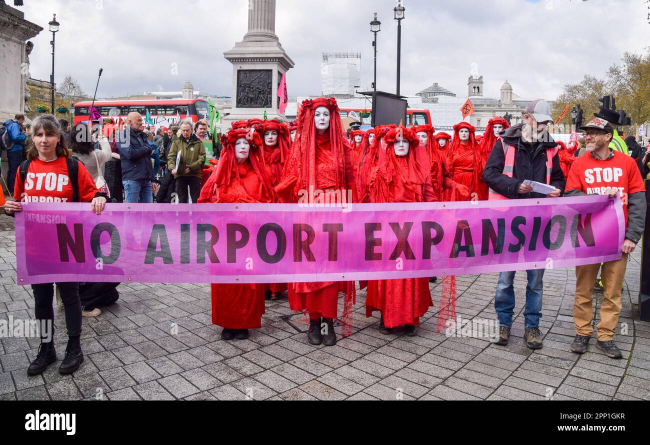 London, UK. 21st April 2023. Red Rebels pass through Trafalgar Square as Extinction Rebellion ...