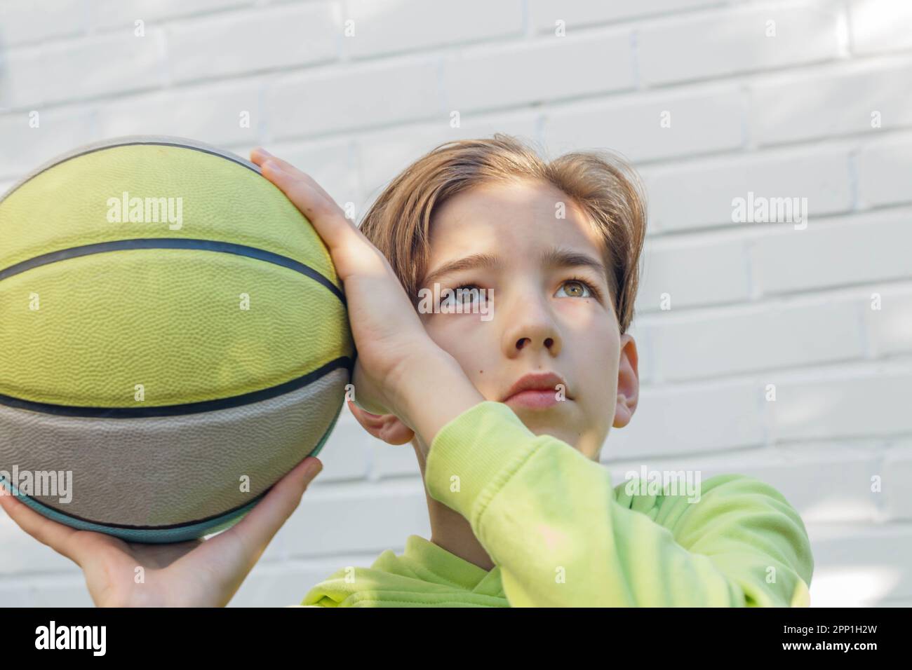 Close-up of a teenager throwing a basketball into the hoop Stock Photo ...