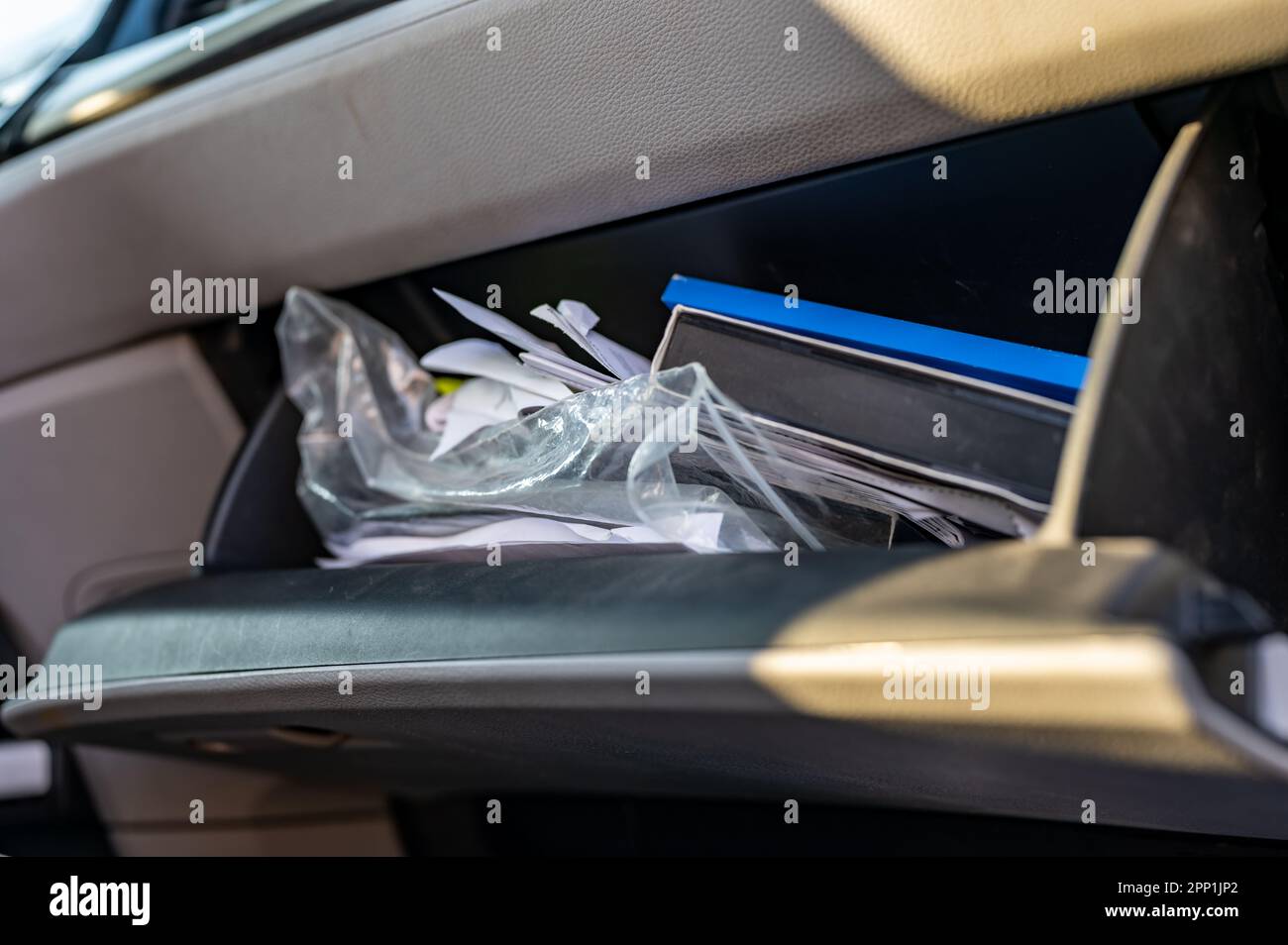 Unorganized mess inside an open glove compartment of a vehicle Stock ...