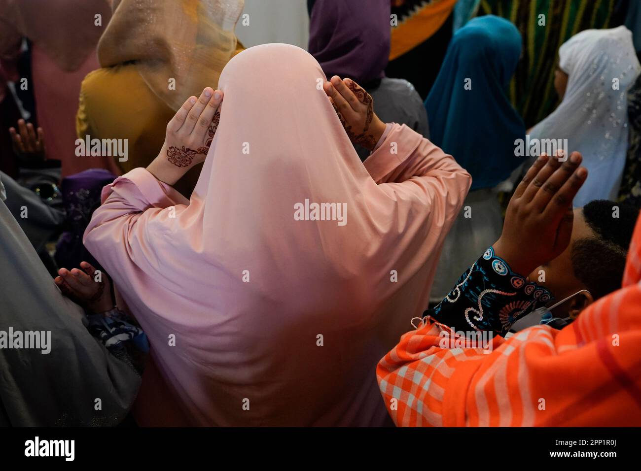 Women pray during Eid al-Fitr, Friday, April 21, 2023, at the Muslim ...