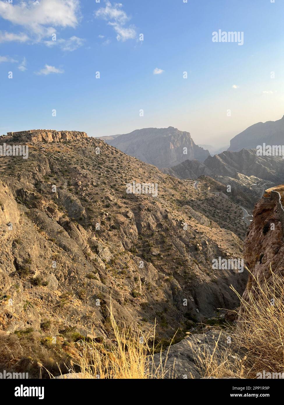 An aerial view of a majestic mountain range, featuring a desolate ...