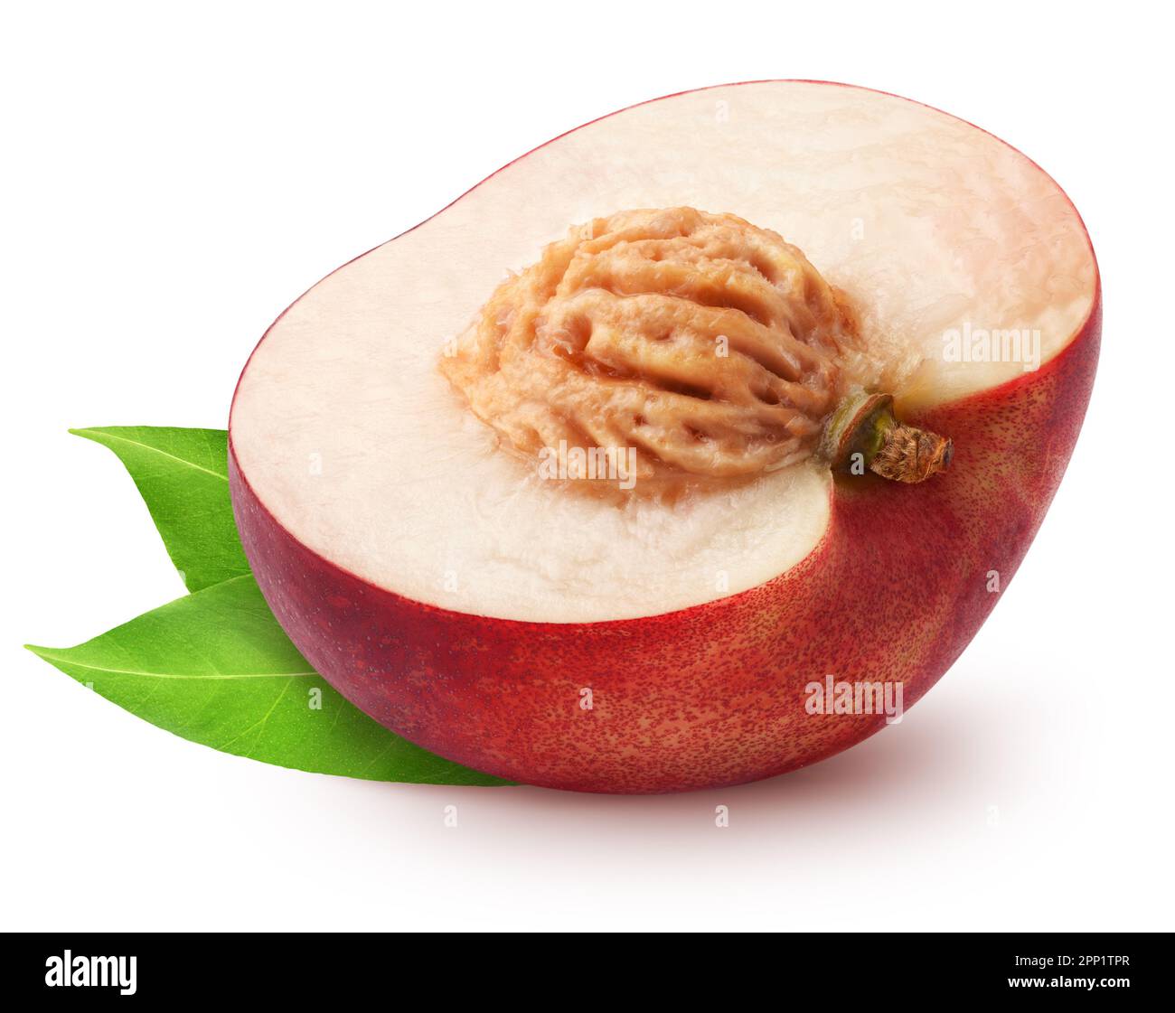 Half of (cut) nectarine fruit with leaves isolated on white background ...