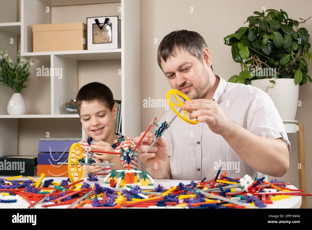 Dad and son build figures from the constructor. Spending time together ...