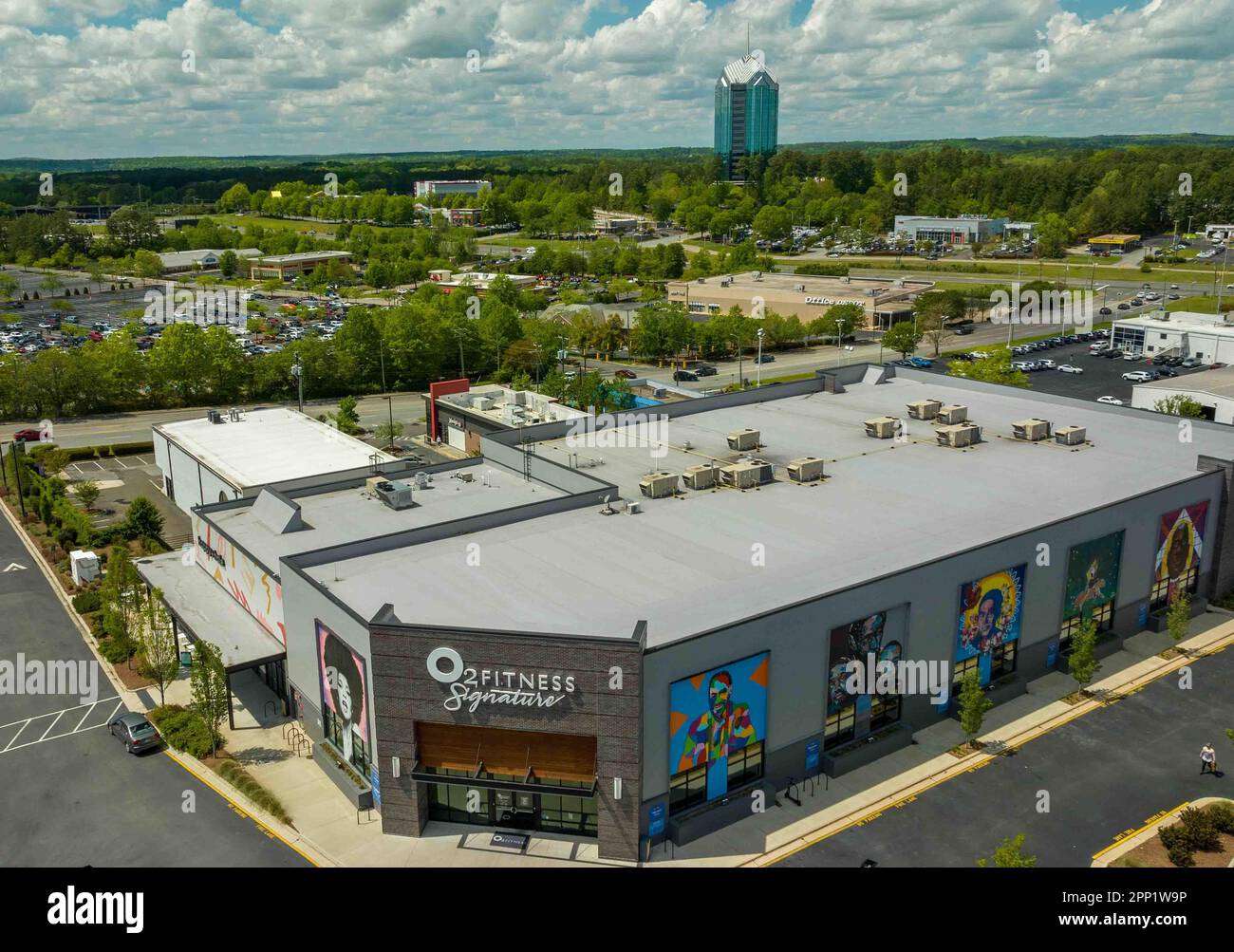 An aerial view of a shopping mall with stores, parking lot, and ...
