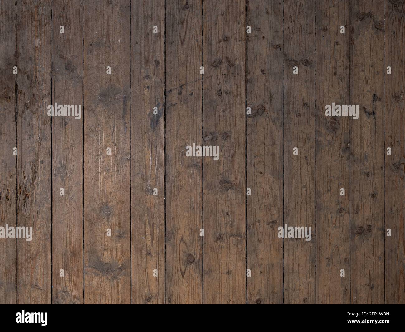 Weathered wooden flooring in a house. Wood grain of dark timber planks ...