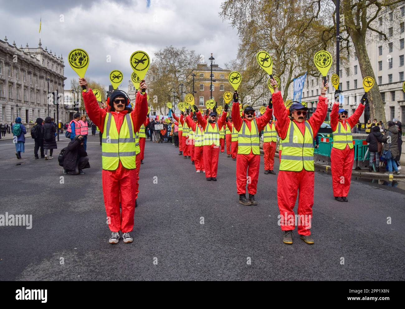 London, UK. 21st April 2023. Protesters against airport expansion pass ...