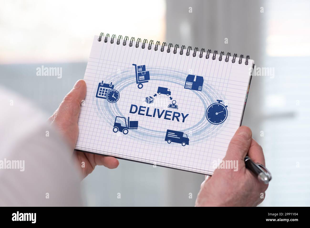 Hand holding a notepad with delivery concept Stock Photo - Alamy