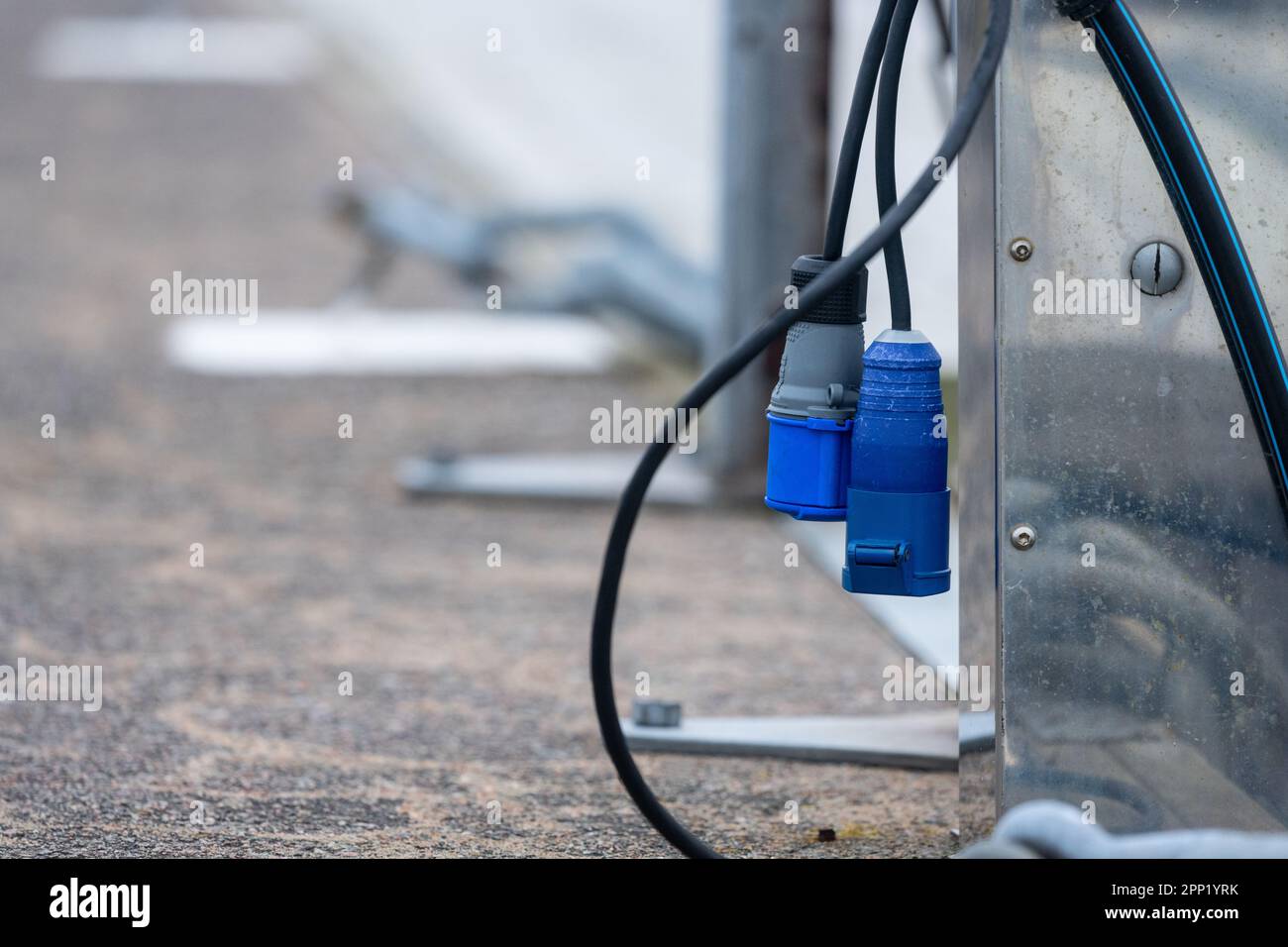 Blue power cables hanging from a junction box Stock Photo - Alamy