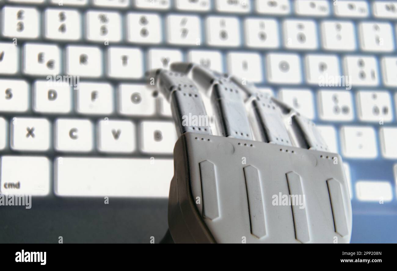Robotic hand typing on a keyboard . Concept of future and AI Stock ...