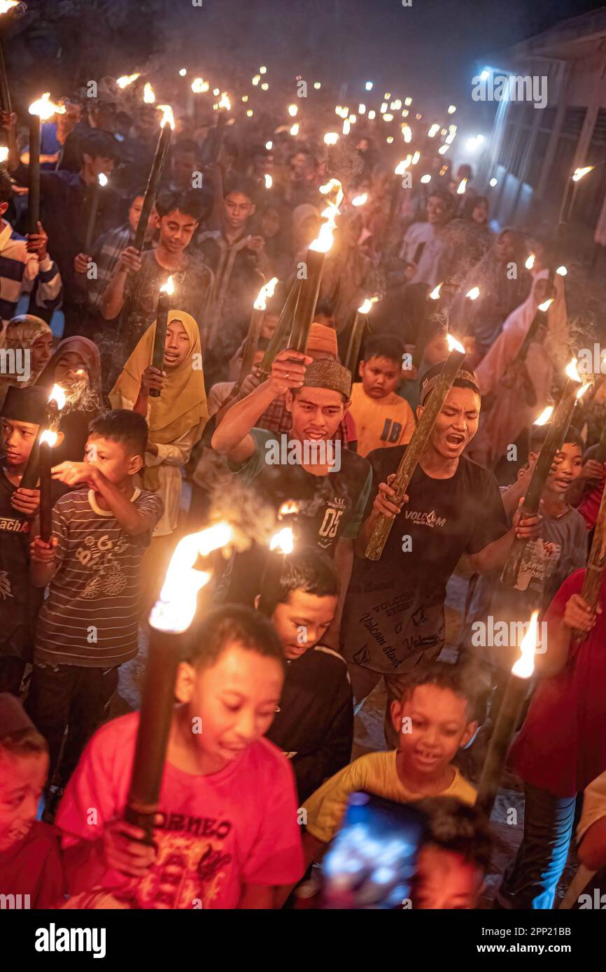Participants hold torches during the Torch relay to welcome Eid al-Fitr ...