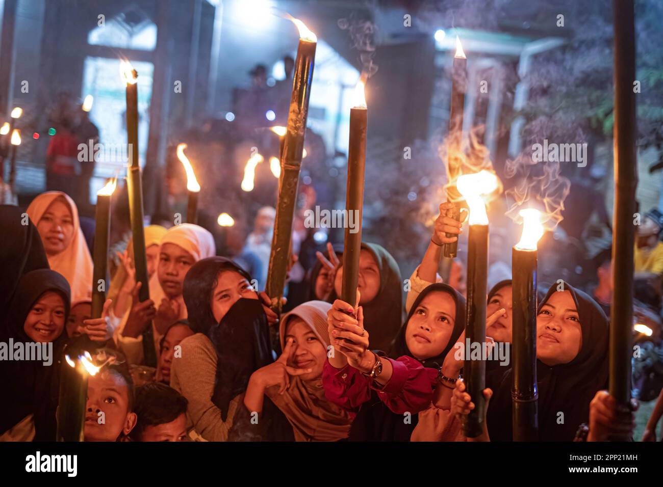 Kendari, Indonesia. 21st Apr, 2023. Participants hold torches during ...