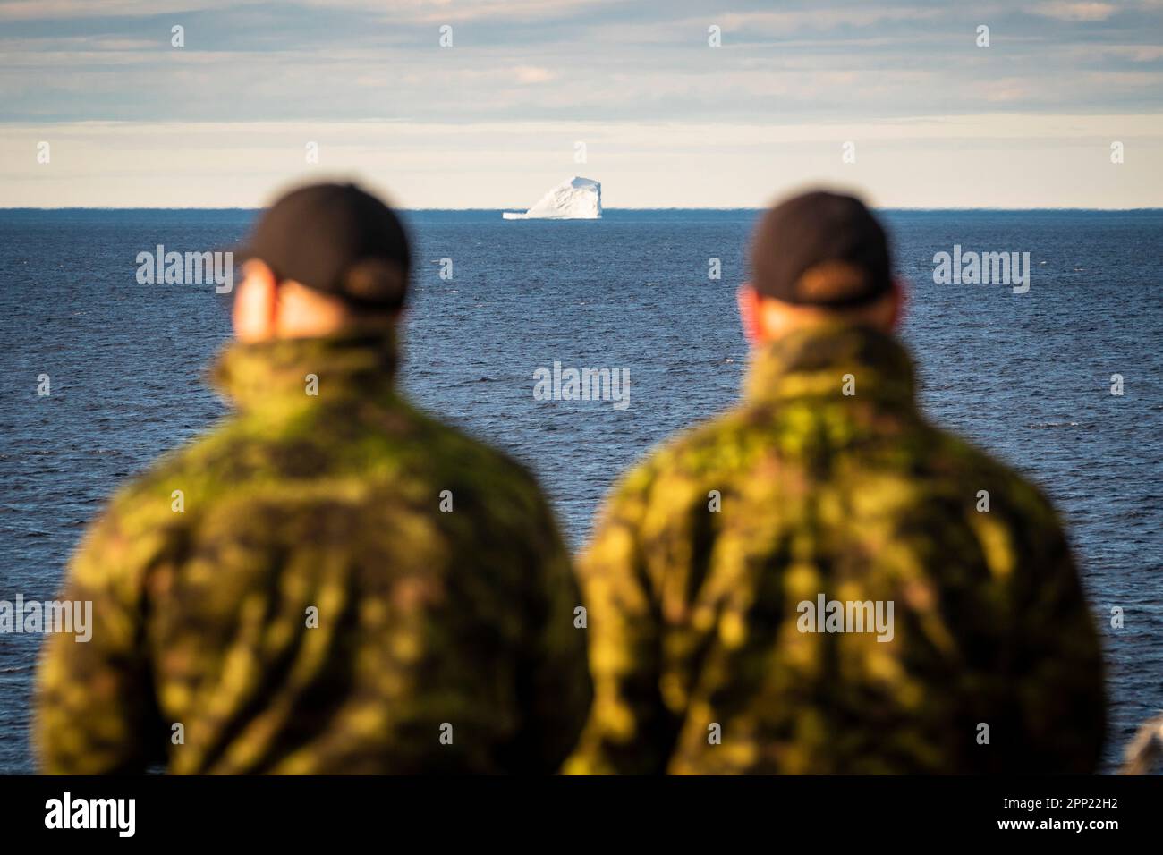 Two Canadian military personnel in camouflage uniform look into the ...