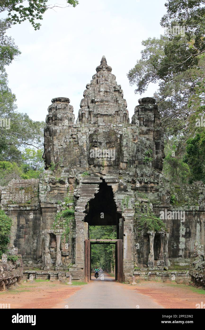 An antique statue standing majestically in the Angkor Wat temple ...
