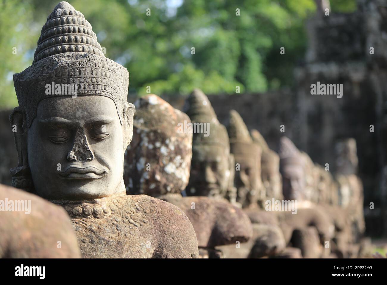 An antique statue standing majestically in the Angkor Wat temple ...
