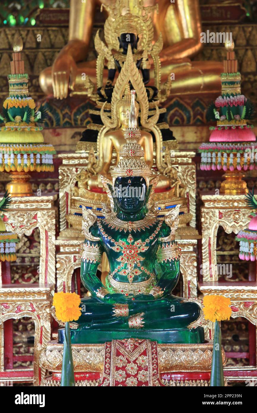 A collection of ornate, colorful Buddha statues with intricate gold ...
