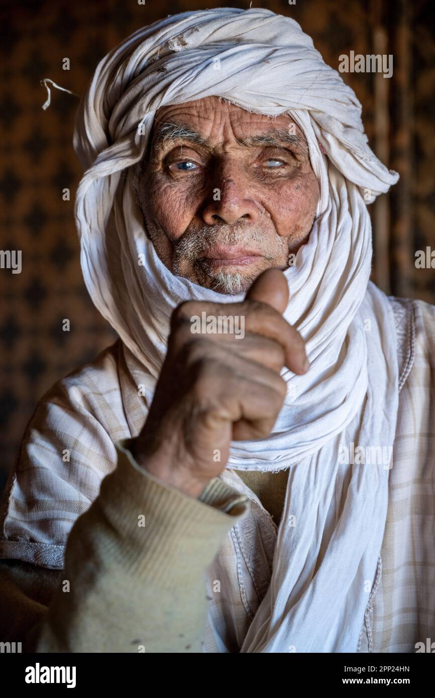 Portrait of Berber elder inside a tent in his Erg Chegaga nomad camp ...