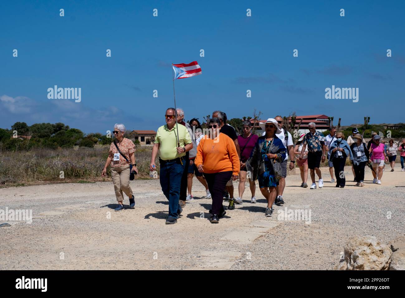 Tour guides escort a group of foreign tourists around the Paphos ...