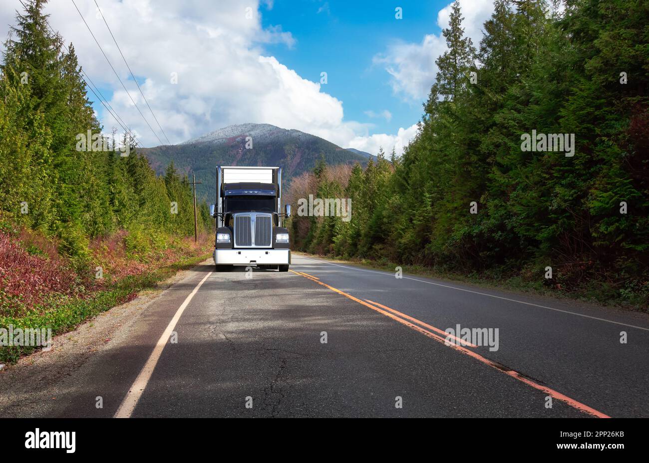 Commercial Truck Driving on Scenic Road with green Trees and Mountains ...