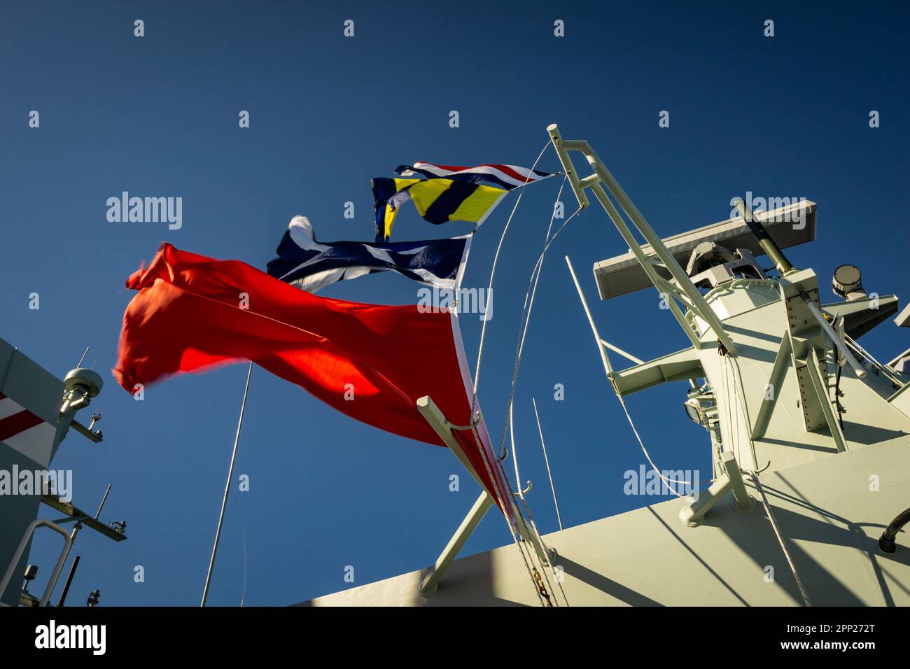 Sailor raising a hoist of signal flags onboard HMCS Margaret Brooke ...