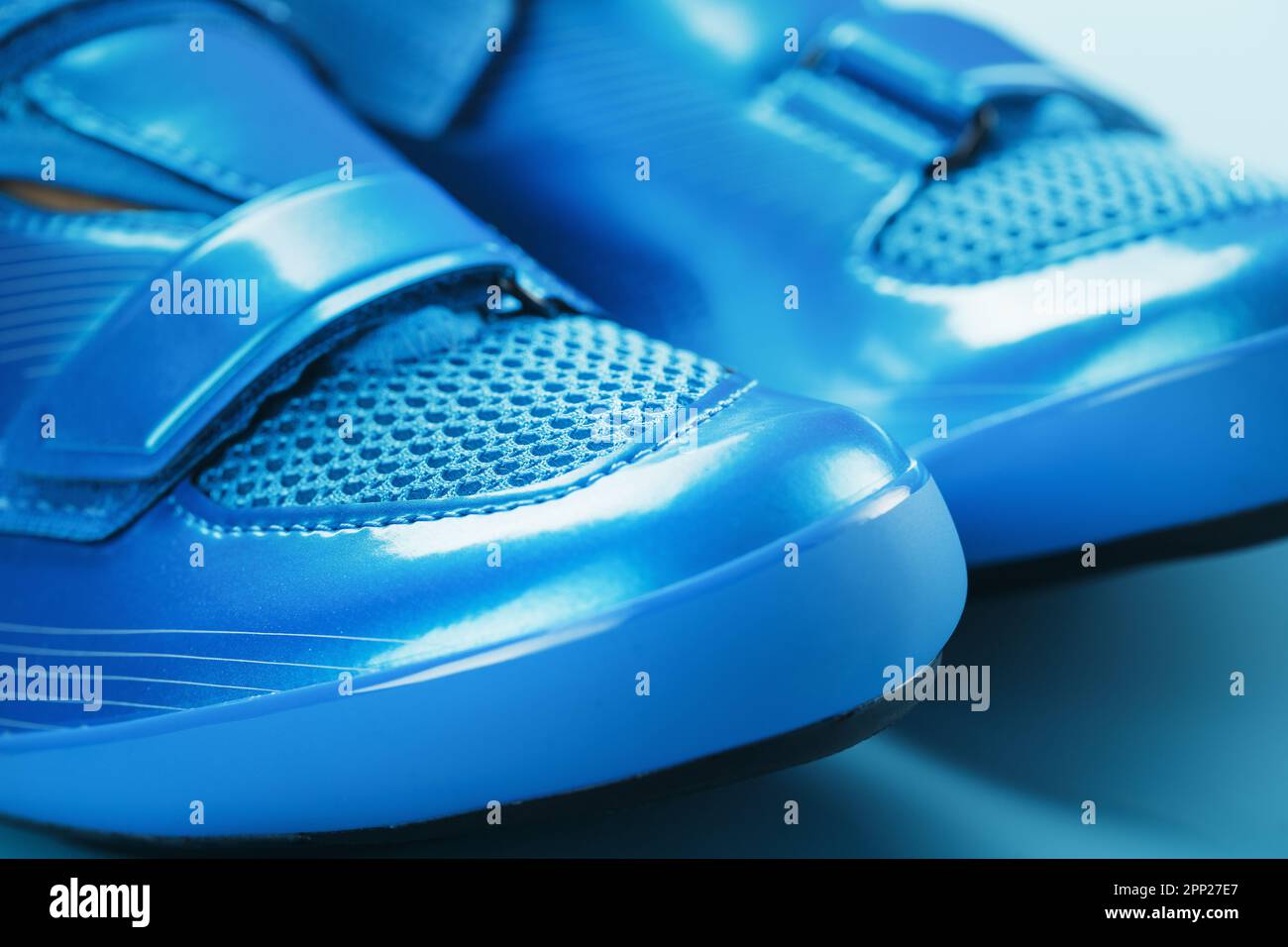 Blue Shiny Bicycle Shoes for Road Bike on Blue Background Stock Photo ...