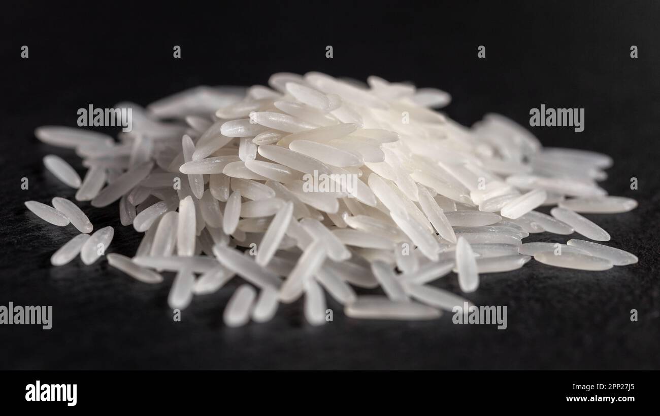 White rice on a black graphite stone slab, healthy food Stock Photo - Alamy