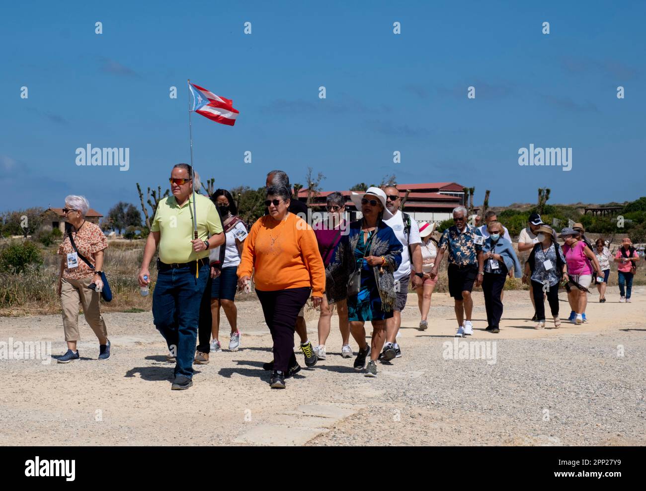 Tour guides escort a group of foreign tourists around the Paphos ...