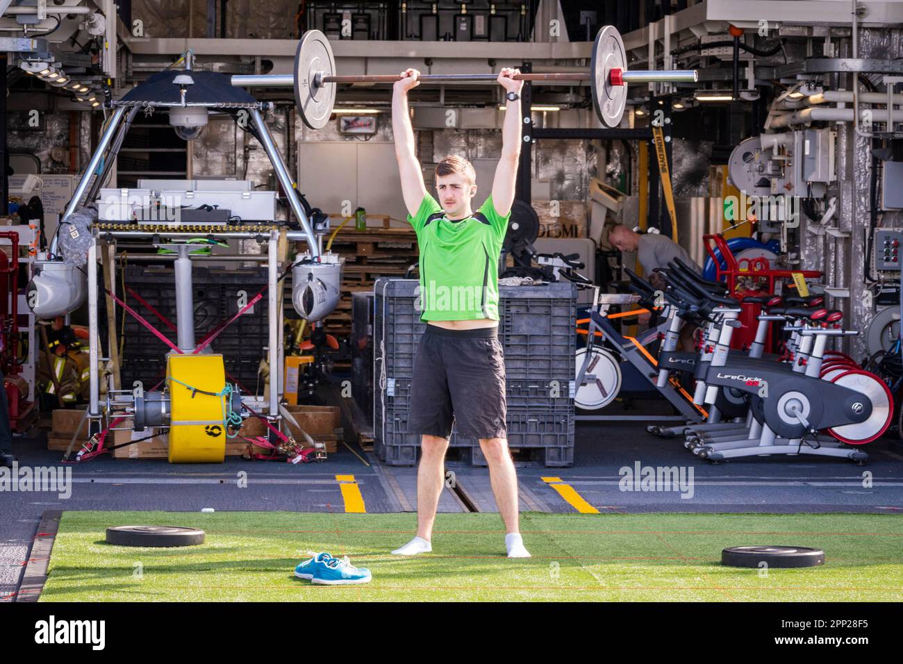 Officer works out with weights stored in the helicopter hangar onboard ...
