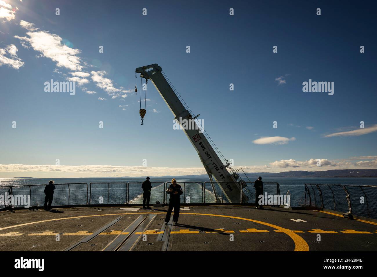 Sailors use the hydraulic crane at the stern of HMCS Margaret Brooke to ...