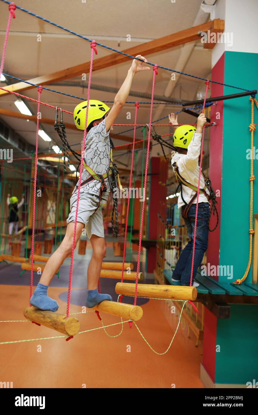 boy passes an obstacle course, cable car. Children's entertainment ...